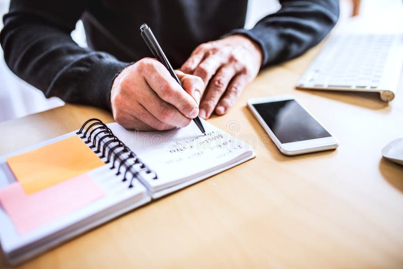 Close Up of Man Writing Notes in Planner, Working at Desk from Home ...