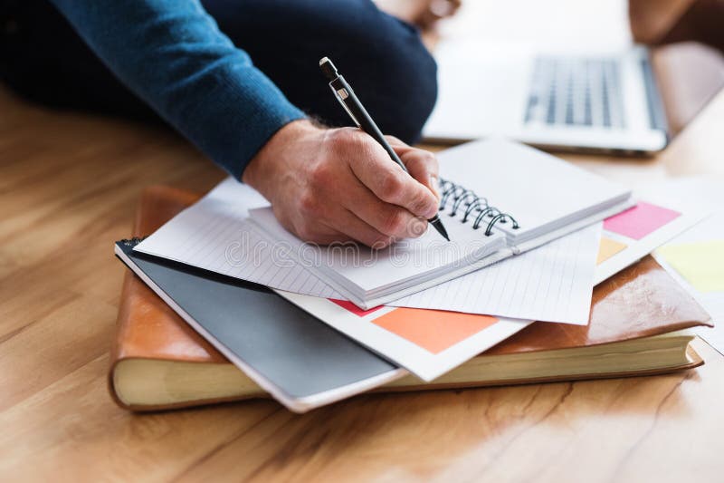 Close Up of Man Writing Notes in Planner, Working at Desk from Home ...