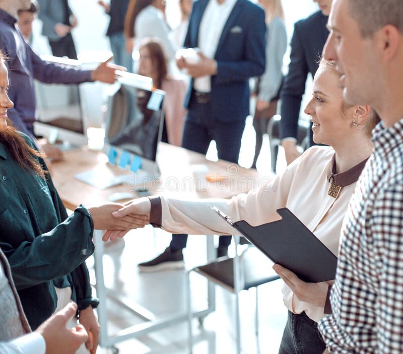 Manager Congratulating a Young Employee with a Handshake Stock Image ...