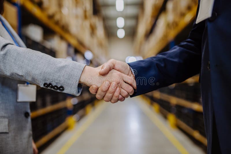 Close-up of Managers Shaking Hands in Warehouse. Stock Photo - Image of ...