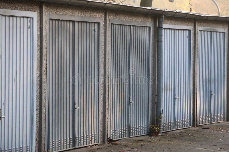 A Close Up of Many Blue Metal Garage Doors in a Row Stock Image - Image ...