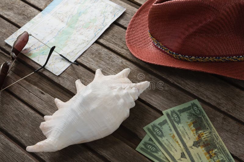 Map, Hat, Seashell, Currency Notes and Sunglasses on Wooden Plank Stock ...