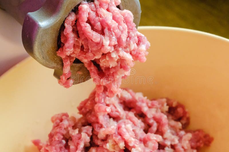 Close Up Meat Grinder or Mincing-machine with Mincemeat in. Showing the ...