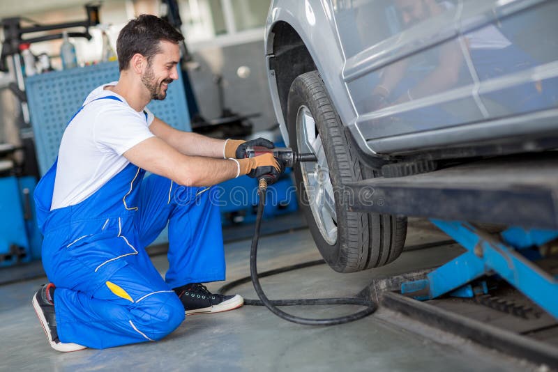 Close Up of Mechanic Changing Wheel Stock Photo - Image of mechanical ...