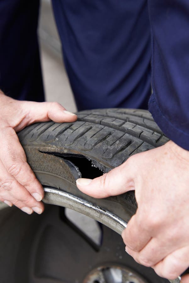 Close Up of Mechanic Examining Damaged Car Tyre Stock Image - Image of ...