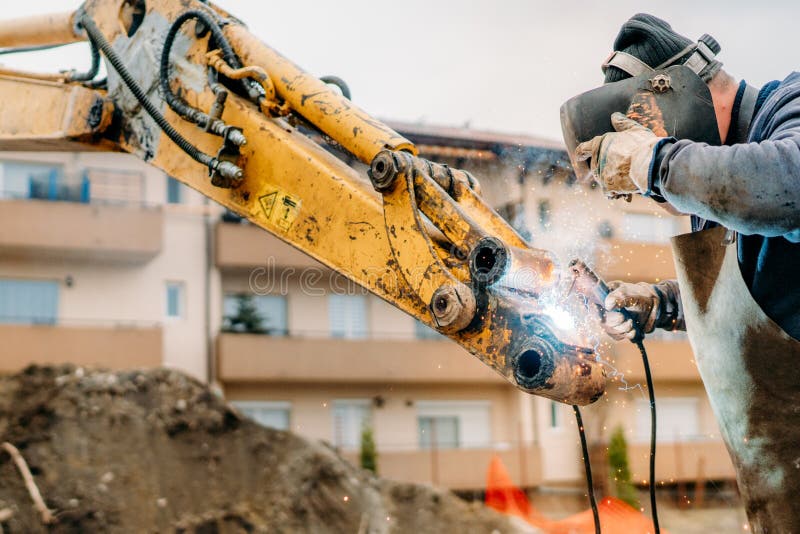 Mechanic Fixing Excavator on Construction Site Stock Photo - Image of ...