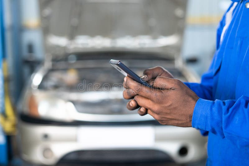 Close Up of Mechanic Hands Busy Using Mobile Phone in Front of Broken ...