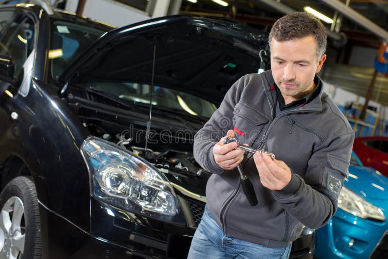 Close Up Mechanic Holding Tool Stock Photo - Image of vehicle, garage ...