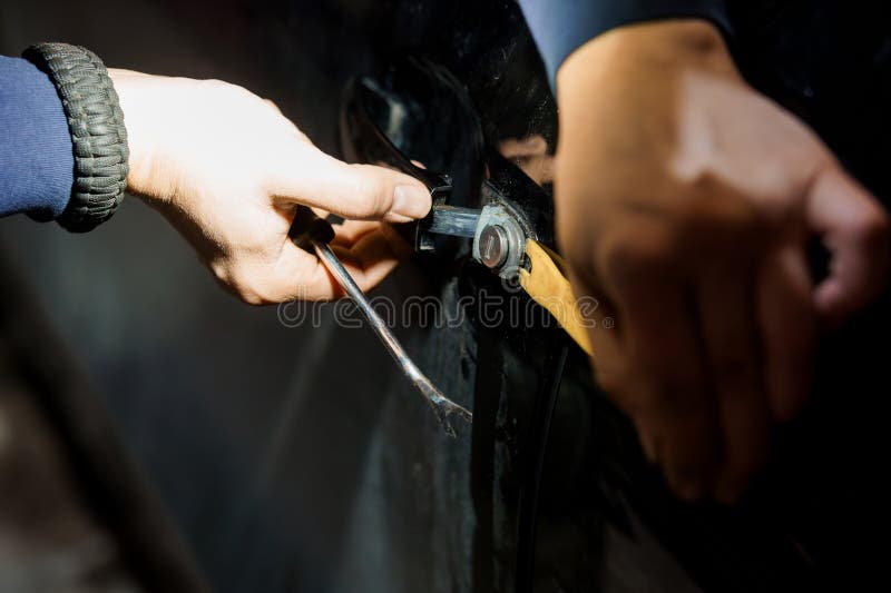 Close-Up of a Mechanic& X27;s Hands Fixing a Car Door Lock Stock Photo ...