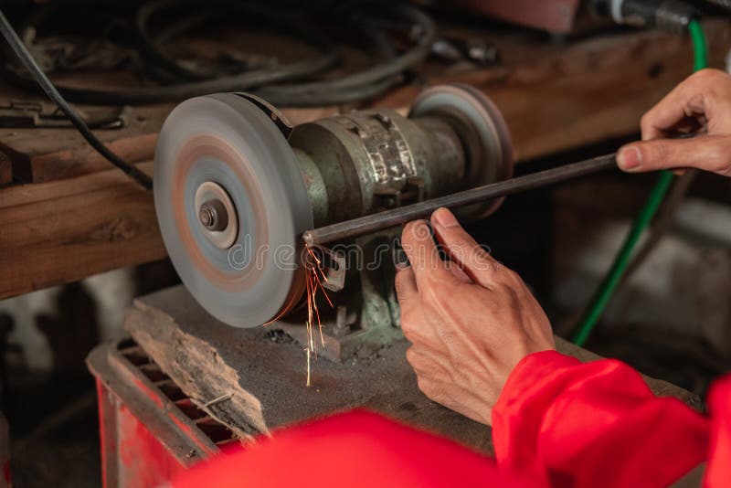 Close Up of Mechanical Hands Using a Grinding Machine To Smooth the ...