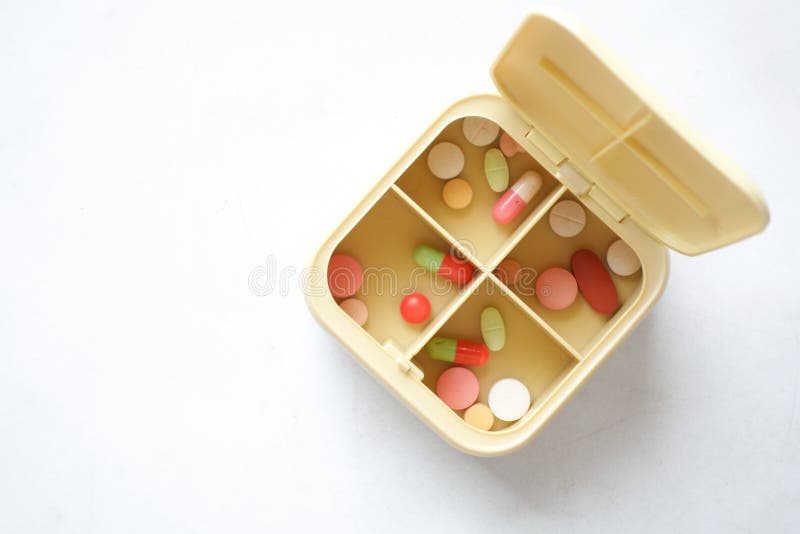 Close Up of Medical Pills in a Pill Box on Table Stock Photo - Image of ...