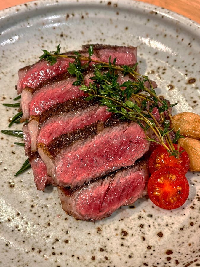 Close Up of Medium Rare Rib Eye Steak with Grilled Vegetable Stock ...