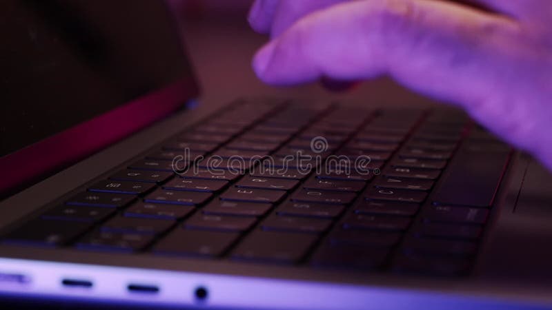A Close Up of Mens Hands Typing on a Keyboard Illuminated by Bright ...