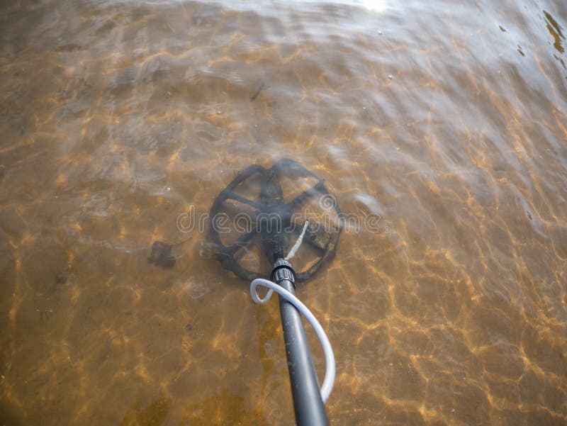Close-up of a Metal Detector Submerged in Water Stock Photo - Image of ...