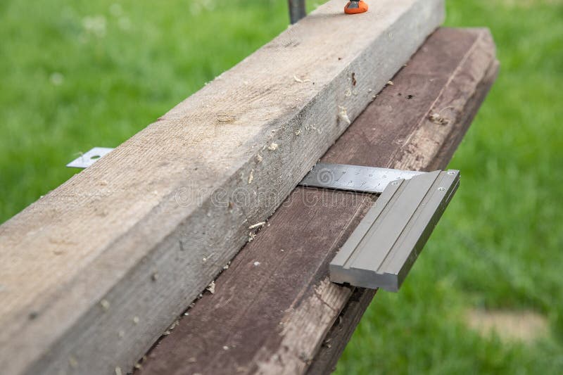 Metal Square Ruler Measuring Wooden Board on Workbench Outdoors Stock ...