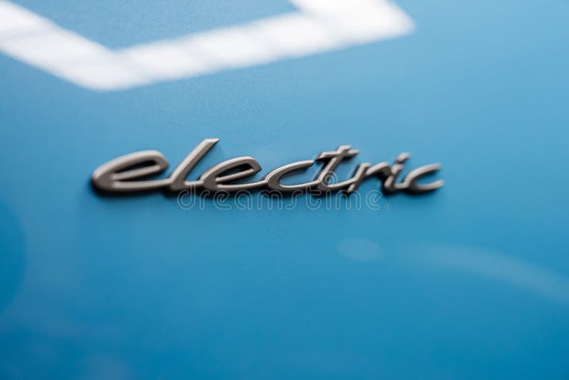 Close Up of Metallic Electric Emblem on Glossy Blue Surface Stock Image ...