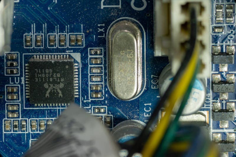 Close-up of Microcircuits and Transistors on Blue Motherboard in ...