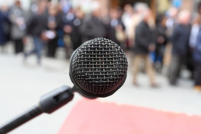 Close-up on the Microphone and the Crowd Blurred Behind Stock Image ...