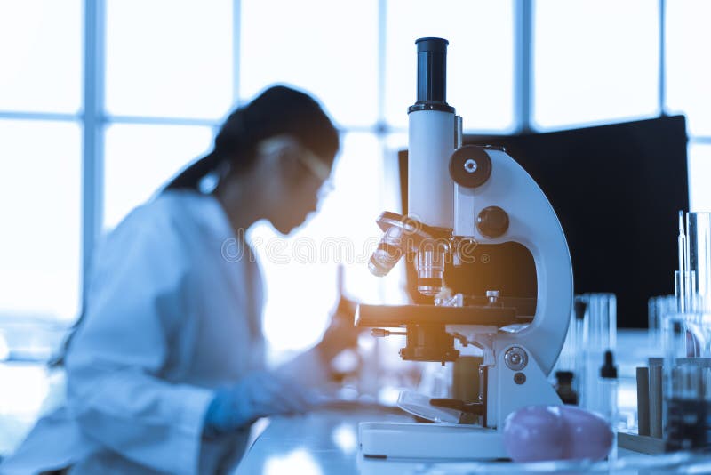 Close Up Microscope in Laboratory with Scientist Background. Stock ...