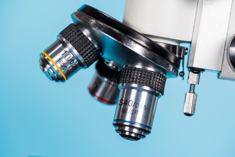 Close Up of Microscope Len on Light Blue Background Stock Photo - Image ...