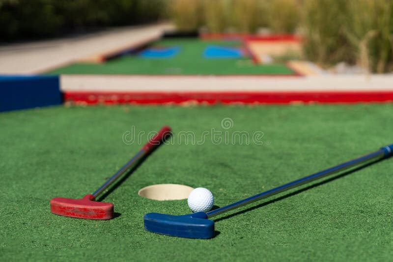 Close-up of Miniature Golf Hole with Bat and Ball Stock Photo - Image ...