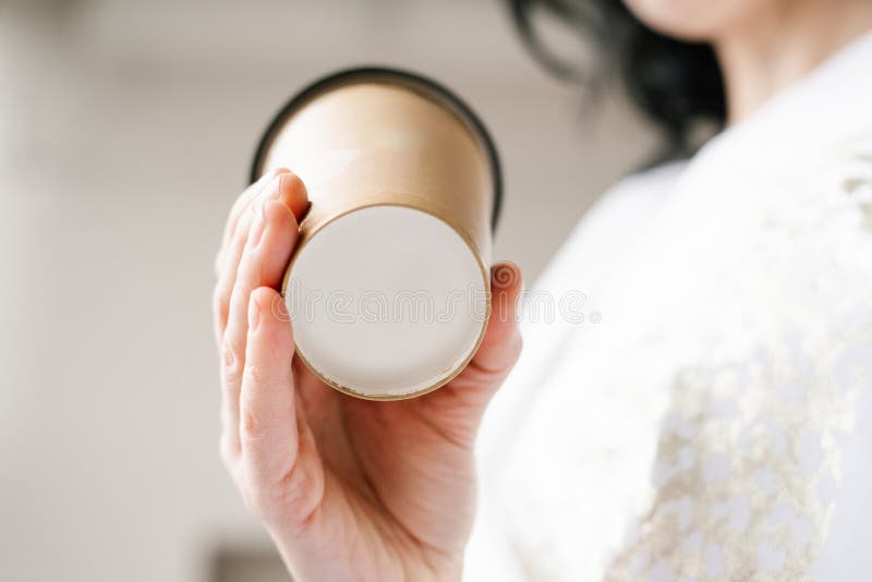 Close Up Mockup of the Bottom of a Paper Cup in the Hands of a Woman ...