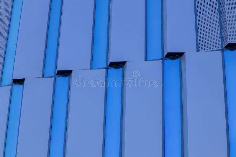 Close-up of a Modern Building Facade with Blue Reflective Glass Panels ...