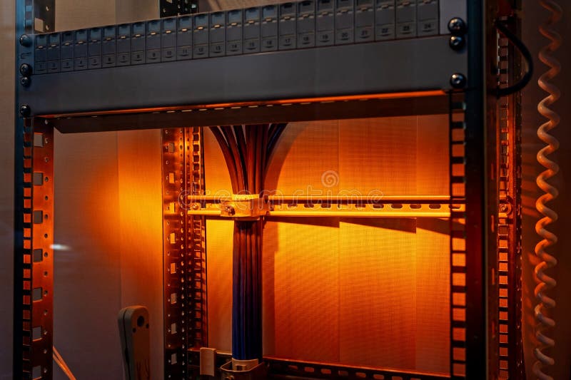 Close Up of Modern Server Rack in a Warm Orange Glow, Highlighting the ...