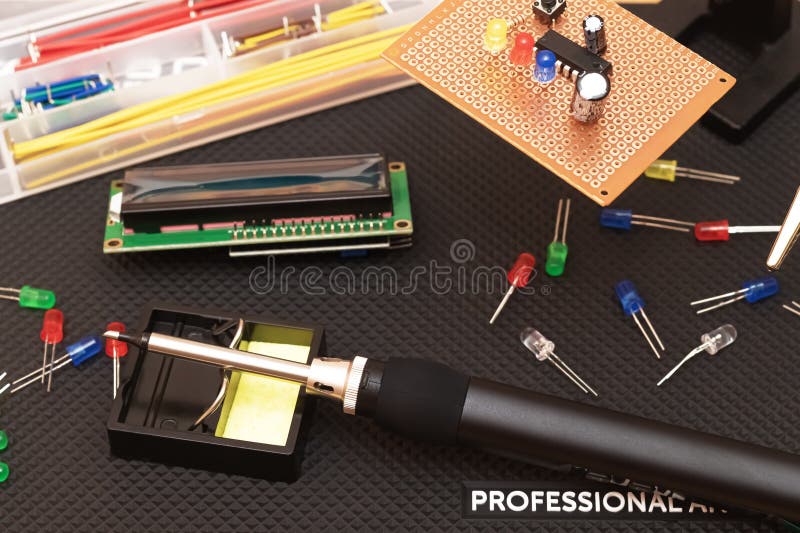 Close-up of a Modern Soldering Iron and Radio Components on a Black ...