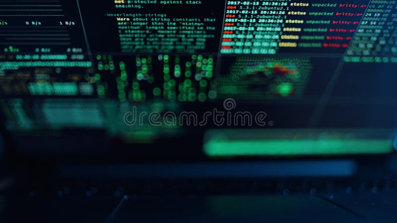 Close-up of a Hacker Typing on a Keyboard in a Dark Room with Glowing Code on Screens Stock ...
