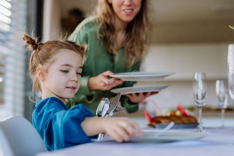 Close-up of Mother with Her Daughter Setting Table, Celebrating Easter. Stock Image - Image of ...