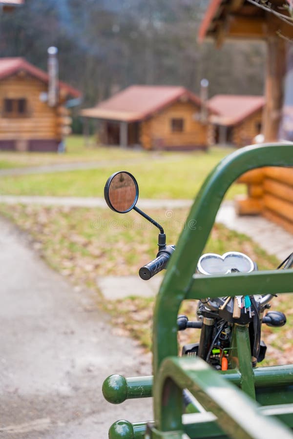 Close-up of a Motorcycle Handle with Rustic Log Cabins in the Czech ...