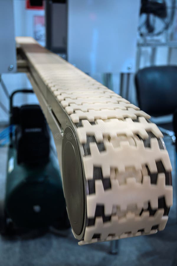 Close-up of a Moving White Modular Conveyor Belt in an Industrial Setting. Automation Technology ...