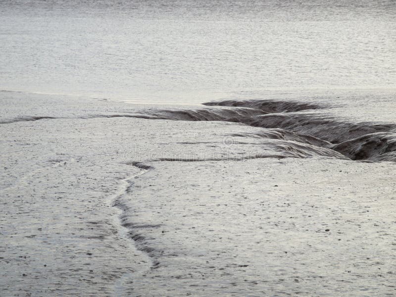 Water drenched mud flats stock photo. Image of seascape - 142260562