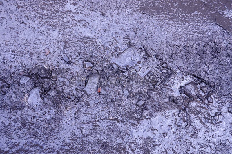 Close Up of Muddy Puddle with Small Stones on Wet Surface. Background ...