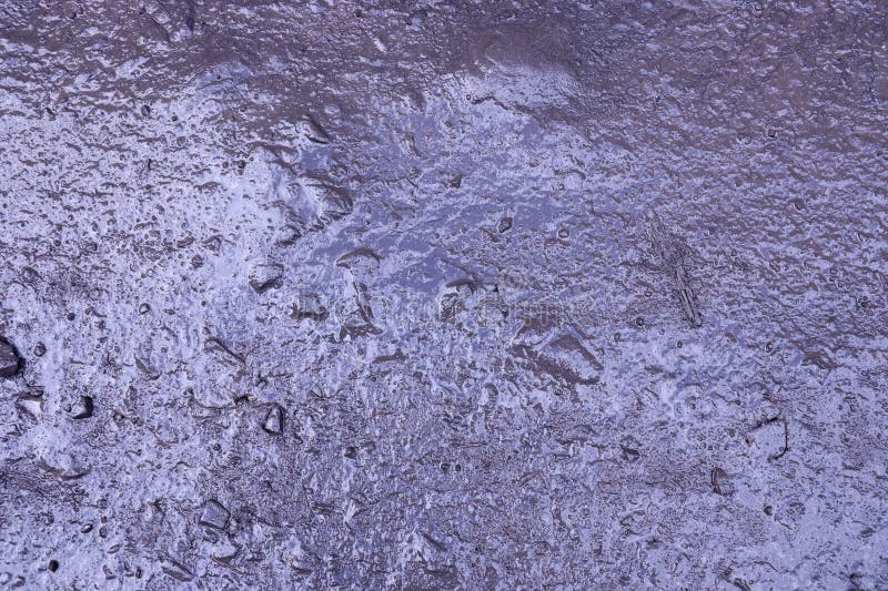 Close Up of Muddy Puddle with Small Stones on Wet Surface. Background ...