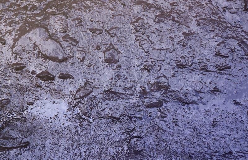 Close Up of Muddy Puddle with Small Stones on Wet Surface. Background ...