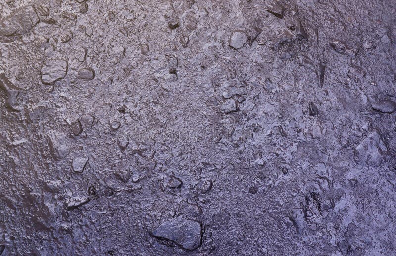 Close Up of Muddy Puddle with Small Stones on Wet Surface. Background ...