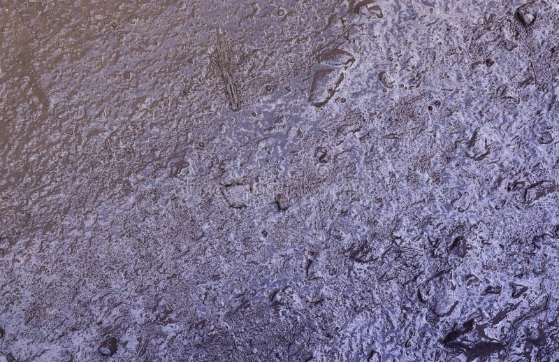 Close Up of Muddy Puddle with Small Stones on Wet Surface. Background ...