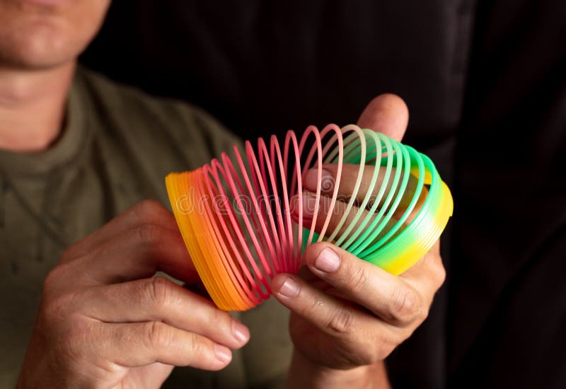 Close-up of a Multi-colored Slinky Spring in a Hand Editorial Stock ...