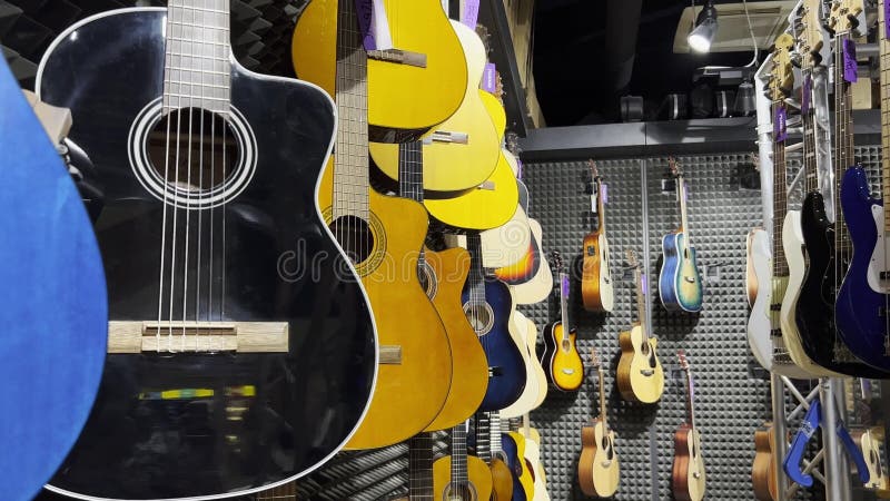 Close Up of Multicolored Acoustic Guitars in a Store. Stringed Musical ...