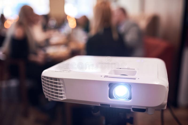 Close-up Multimedia Projector with Blurred People Background Stock ...