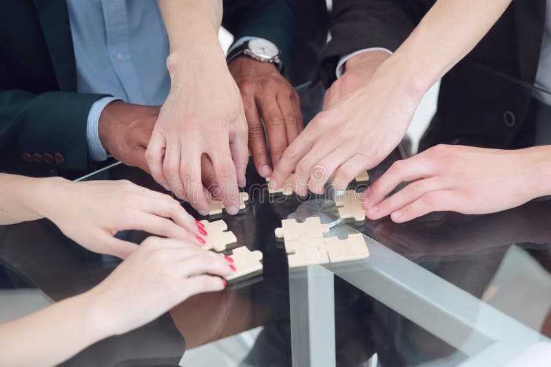 Close Up .multinational Business Team Assembling Puzzle. Stock Image ... Close Up .multinational Business Team Assembling Puzzle. Stock Image ...