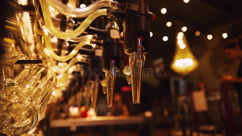 Close-up of Multiple Shiny Beer Taps with Handles, Set Against Blurred ...