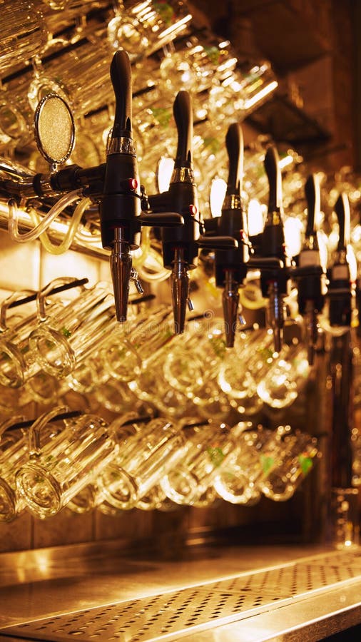 Close-up of Multiple Shiny Beer Taps with Handles, Set Against Blurred ...