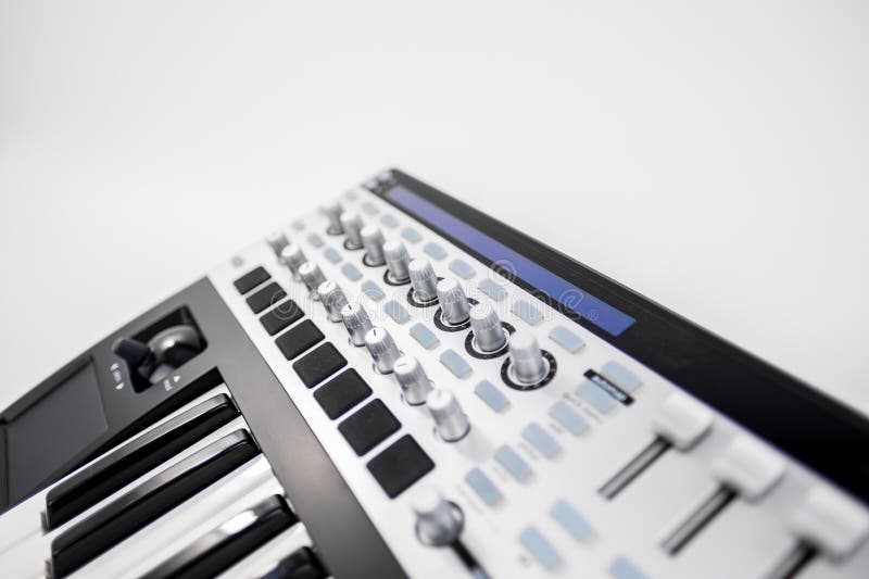 Close-Up of a Music Keyboard Controller and Synthesizer with Controls ...