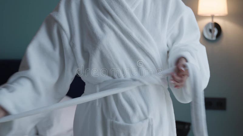 Close-up of Neat Female Hands Tying a Robe, Standing by the Bed. Stock ...