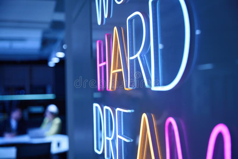 Close-up Neon Phrase on the Wall in the Office Stock Image - Image of ...