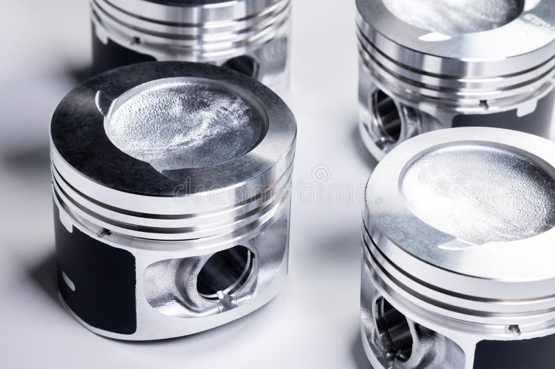 Close-up of Four New Internal Combustion Engine Piston on a Gray ... Close-up of Four New Internal Combustion Engine Piston on a Gray ...