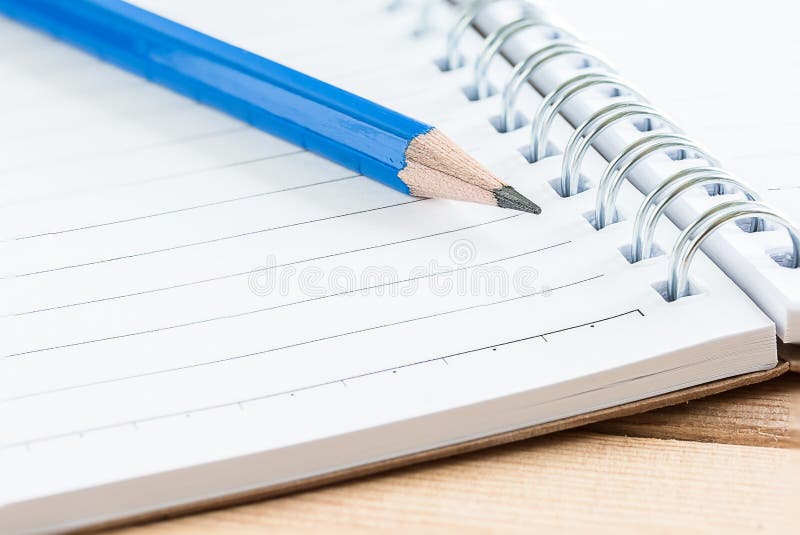 Close-up Notebook and Blue Pencil on Wood Table Stock Image - Image of ...